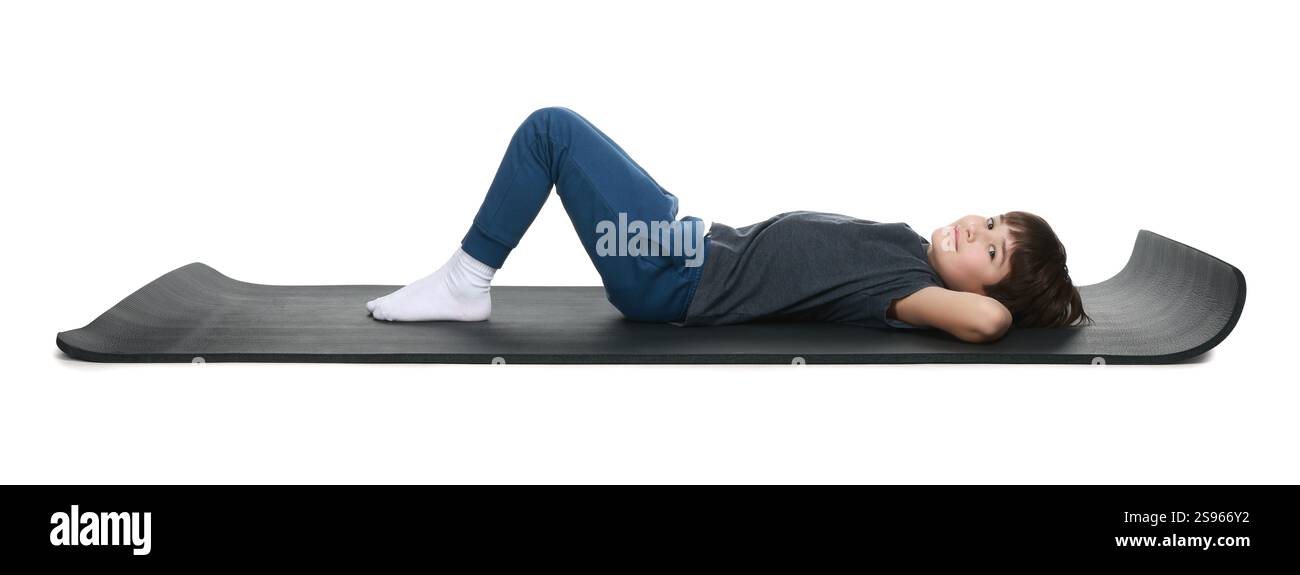 Boy exercising on fitness mat against white background. Sport activity ...