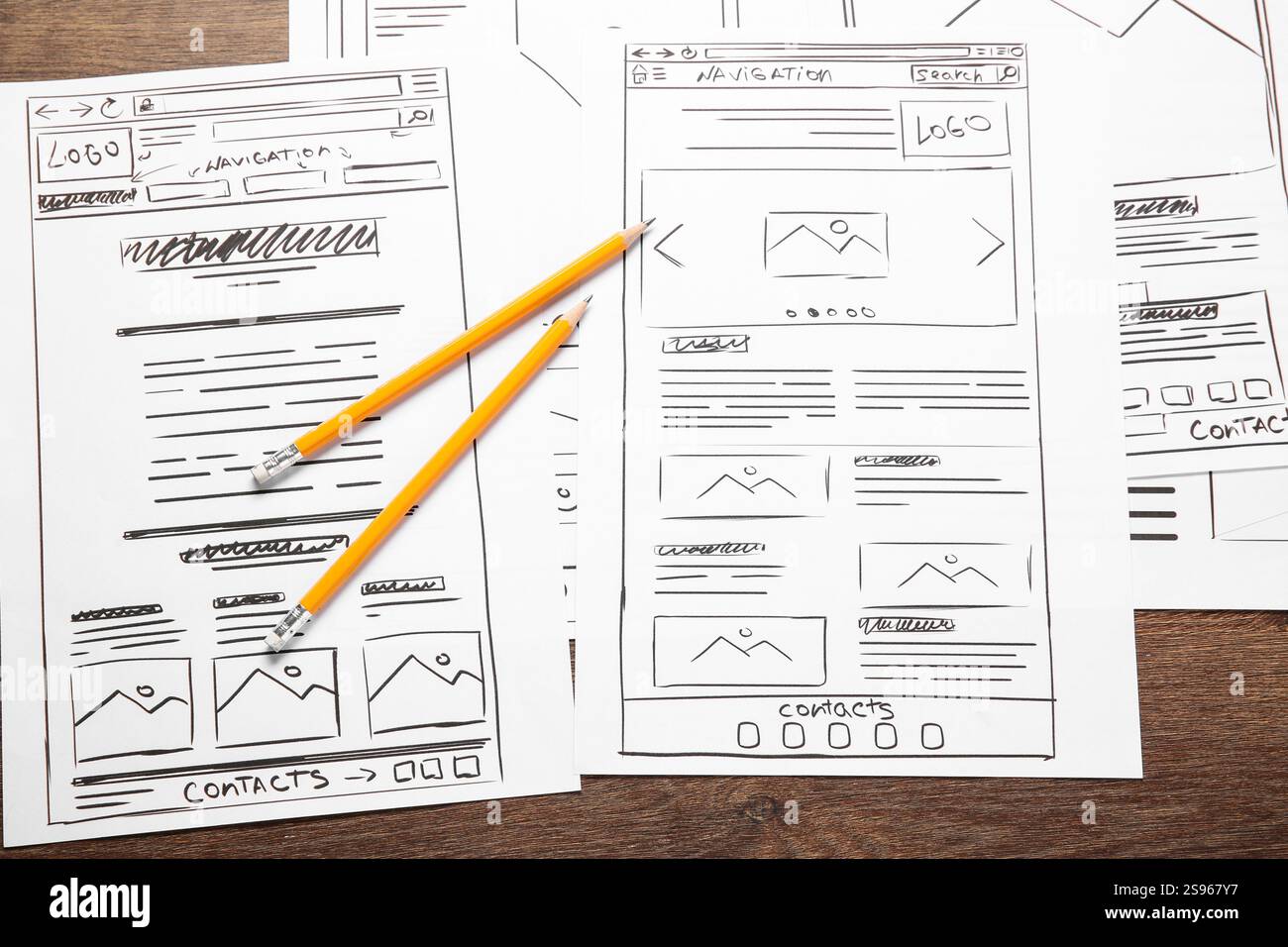 Developing UI design. Sketches of website wireframes and pencils on ...