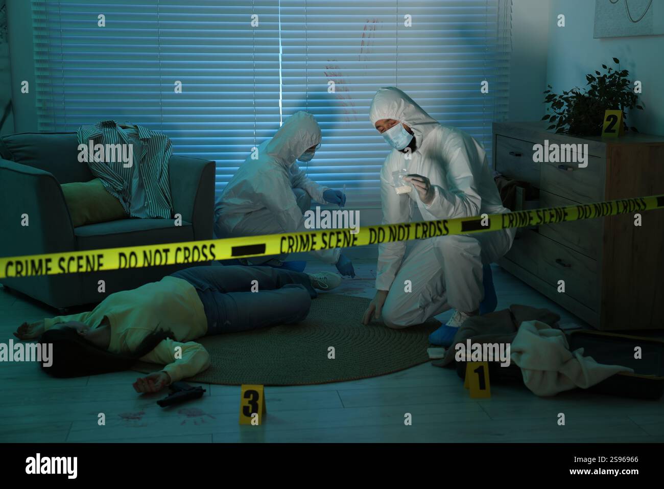 Forensic experts working at crime scene with dead woman's body indoors ...