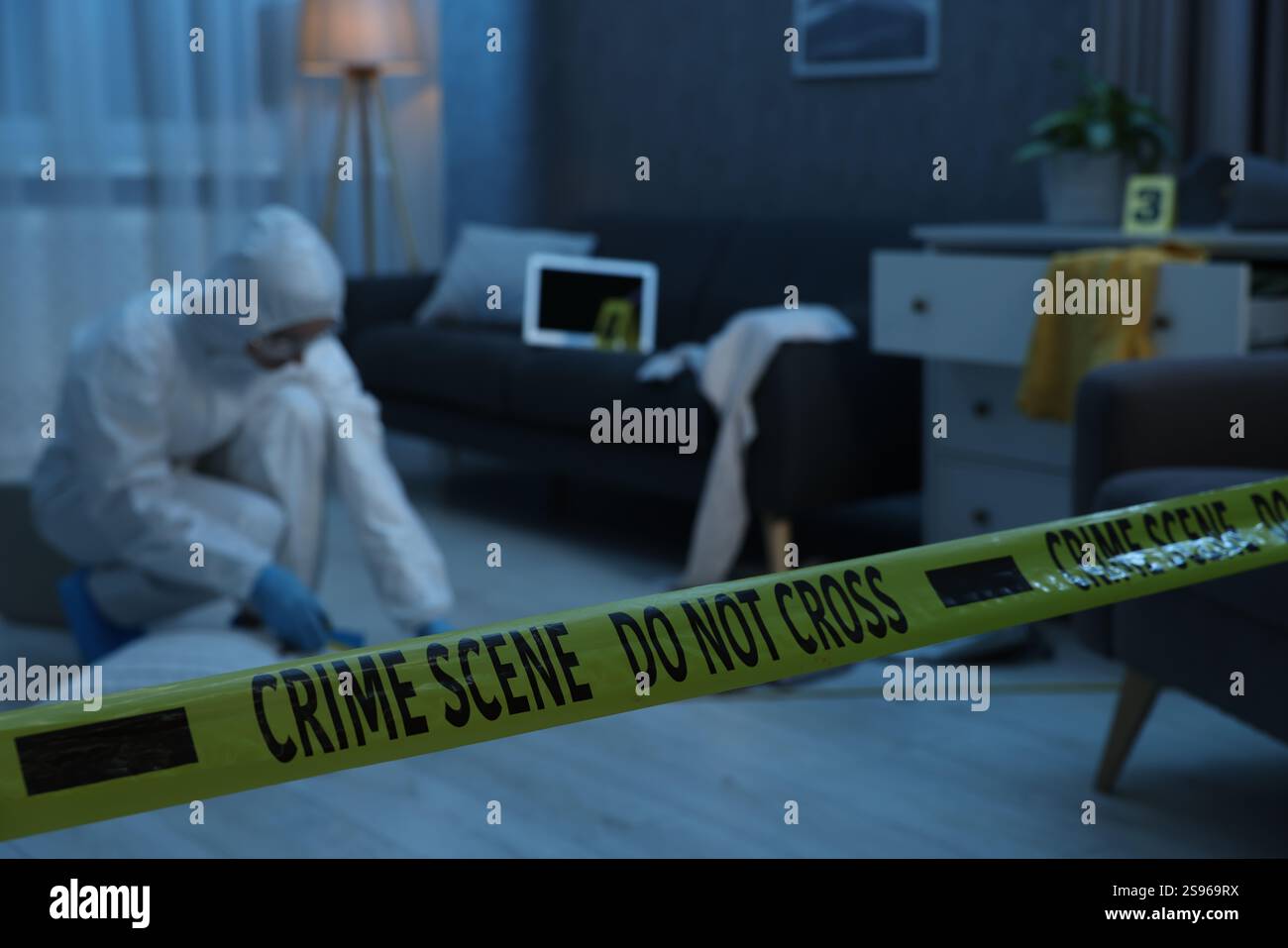 Forensic expert working at crime scene in messy room, focus on yellow ...