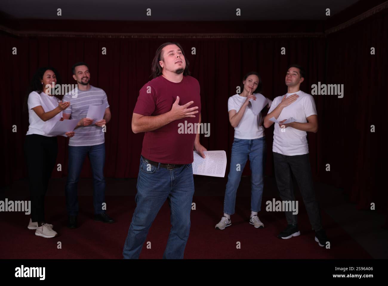 Professional actors with their scripts rehearsing in theatre Stock ...