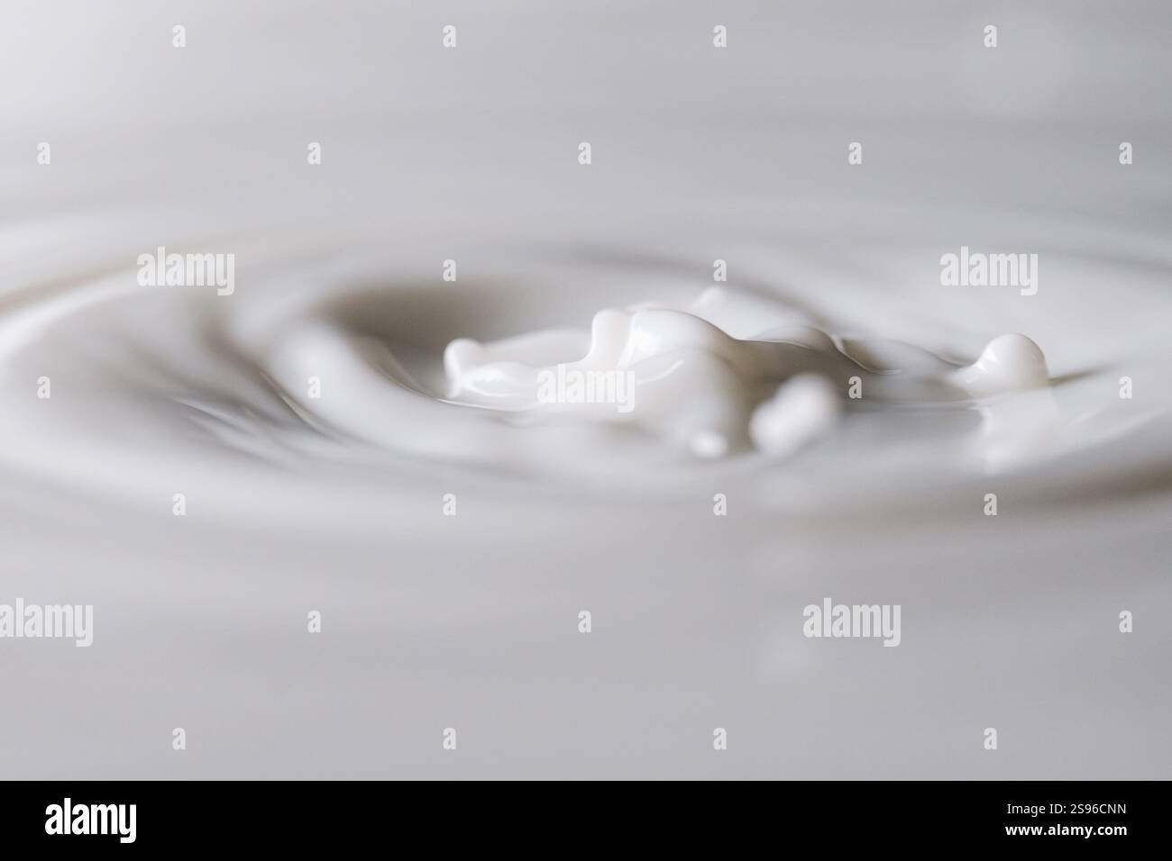 Splashes and ripples on the surface of milk, white liquid surface ...