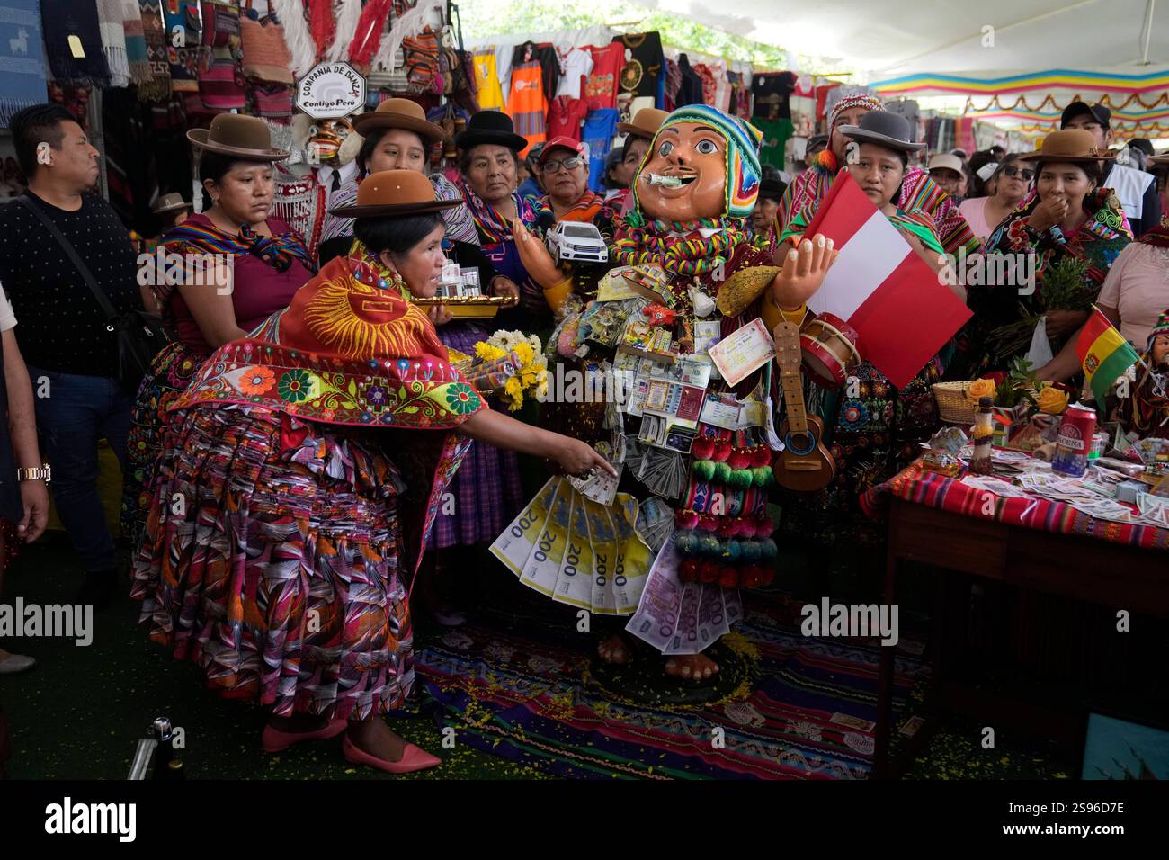 People surround a life-size Ekeko, the Andean god of abundance ...