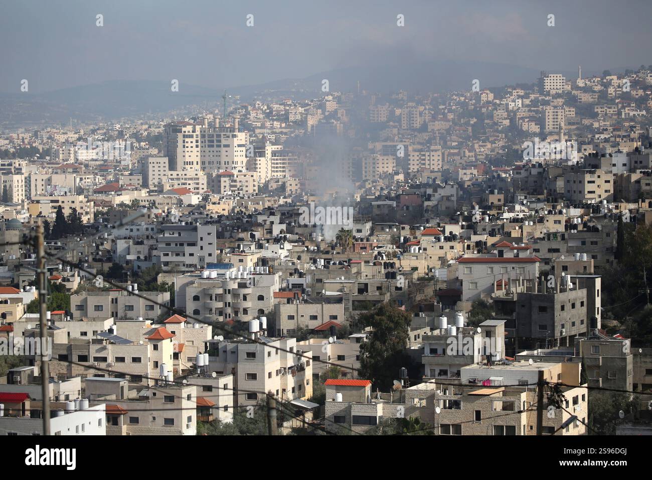 Smoke seen rising over the Jenin refugee camp in the West Bank during ...