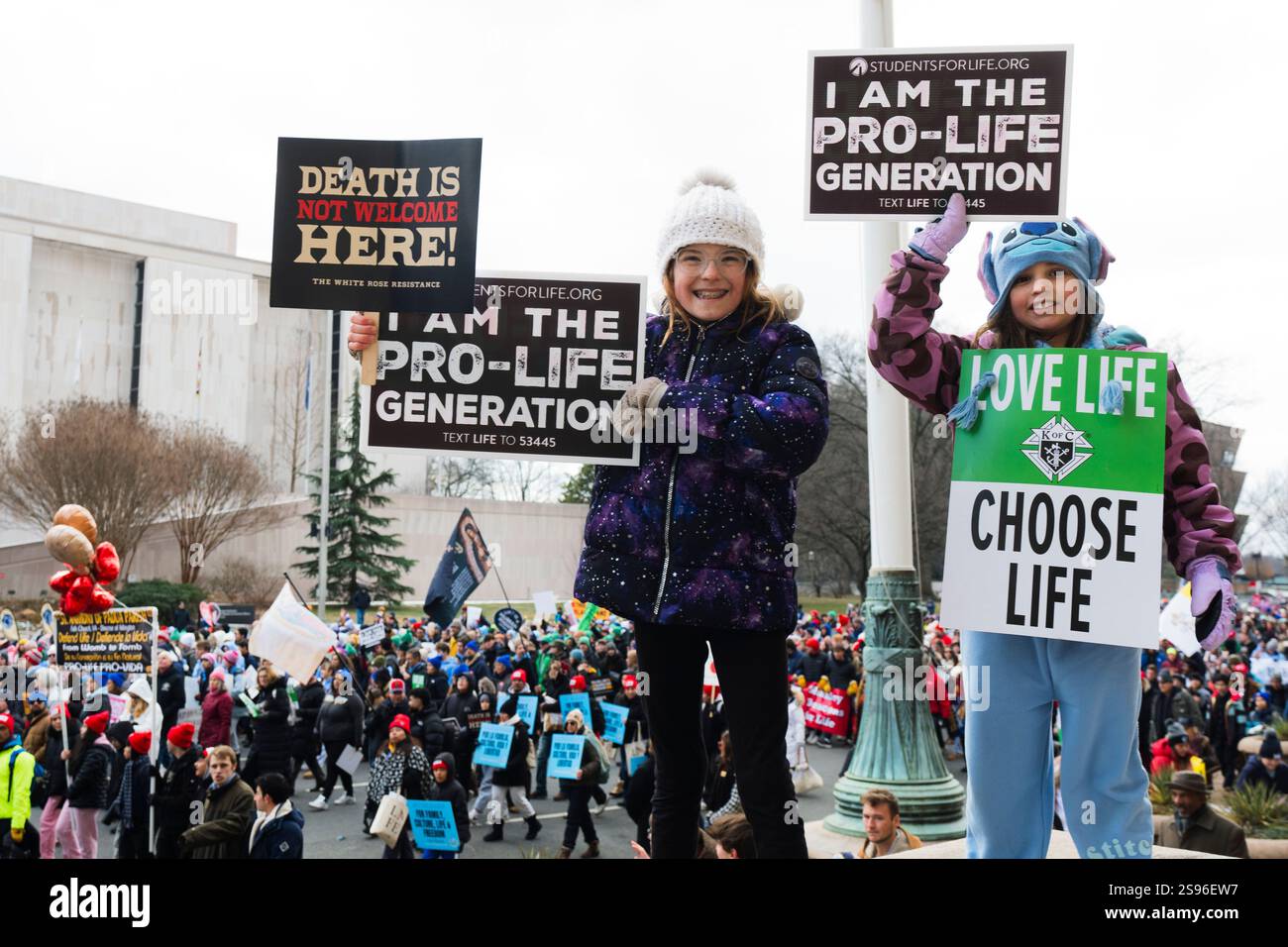 Bernadette Massery, right, and Isabella Brazee, left, wave their ...