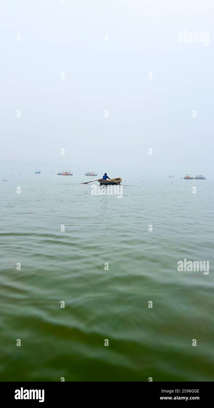 Boatman rowing across the Triveni Sangam in Prayagraj, Uttar Pradesh ...