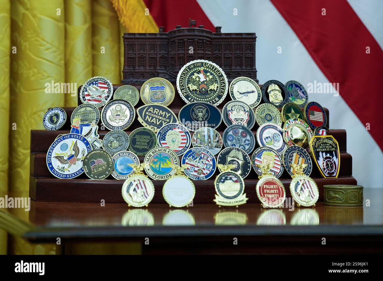 Medals and challenge coins are displayed behind the desk of United ...