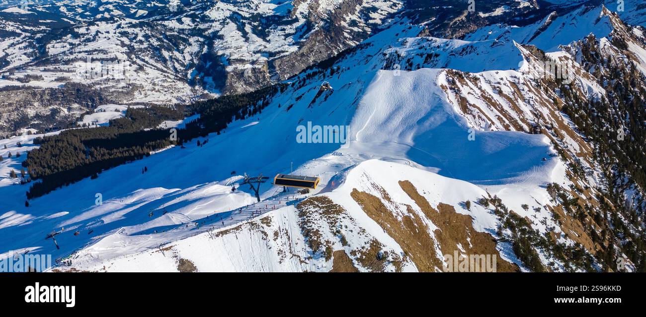 Aerial drone view of snow covered mountains and ski slopes, ski area ...
