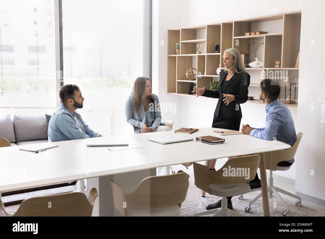Mature female lead training session for staff Stock Photo - Alamy