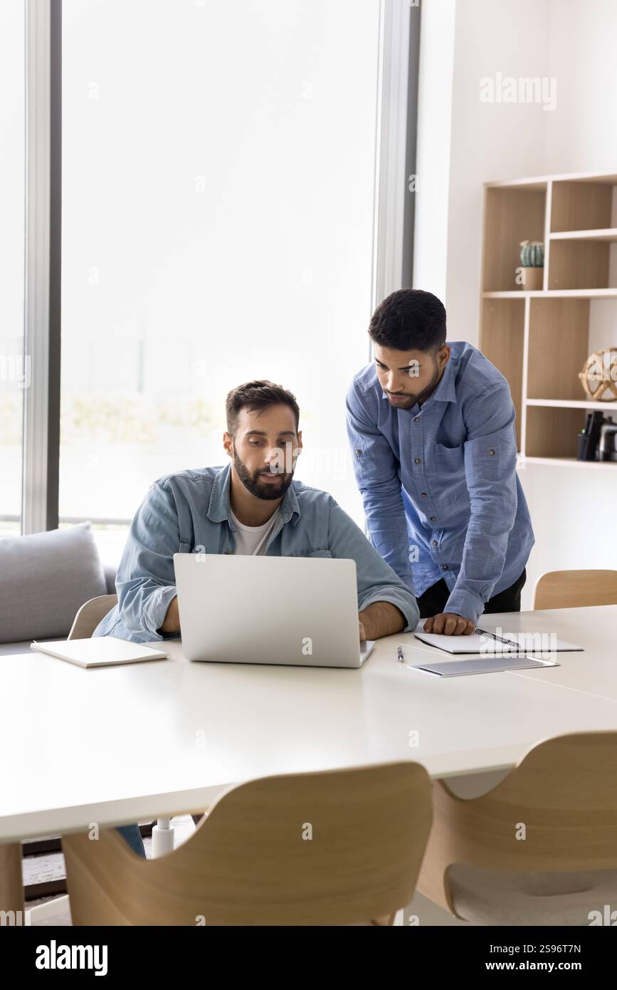 Two colleagues working on task using modern laptop Stock Photo - Alamy