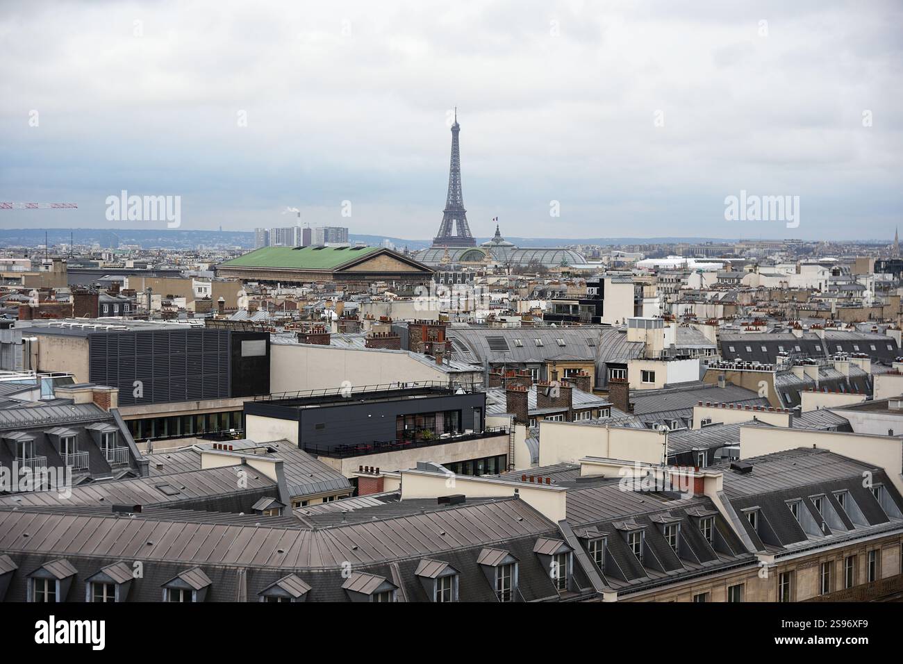 A scenic view of Paris rooftops featuring the iconic Eiffel Tower and ...