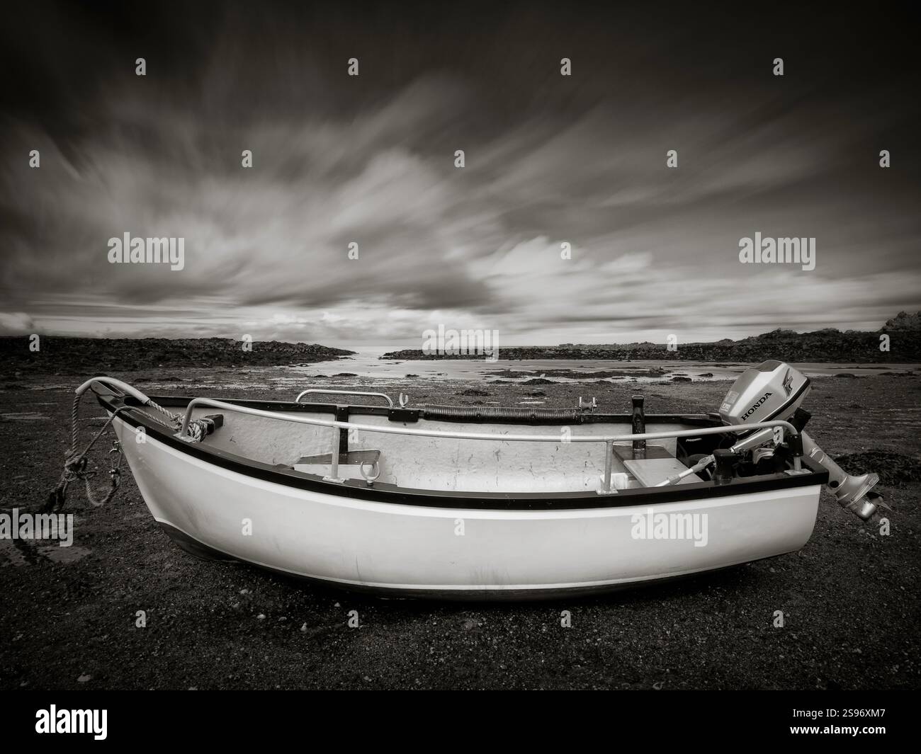 Small inshore fishing boat sat on sand on beach at low tide. Rocquaine ...