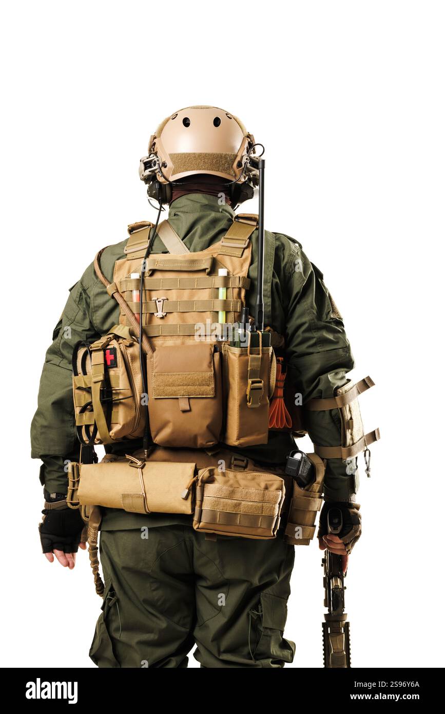 A tactical operator seen from behind, equipped in full gear with ...