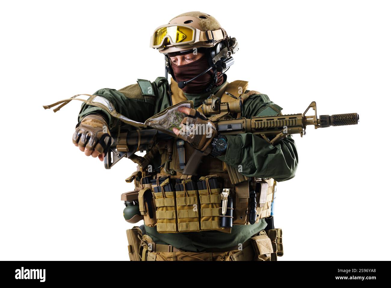 A tactical soldier wearing military gear adjusts equipment while ...