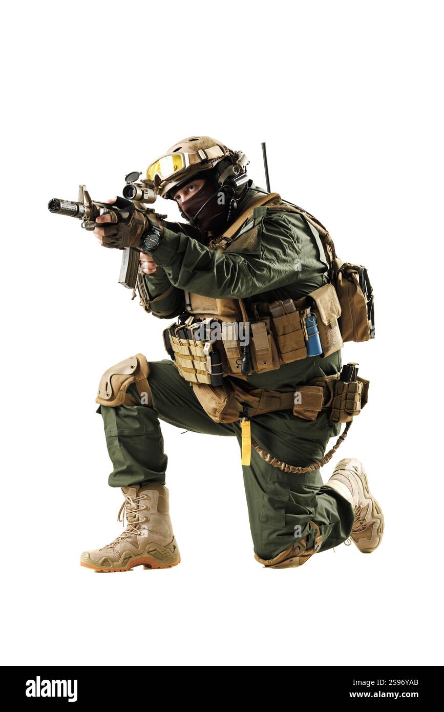 A tactical soldier in action, equipped in advanced combat gear, aiming ...