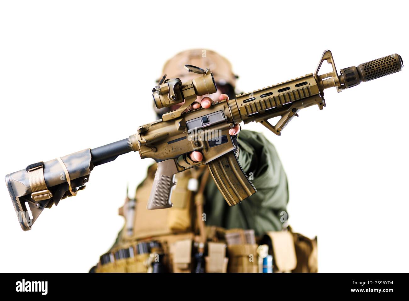 A person dressed in tactical gear holding an assault rifle in a ...