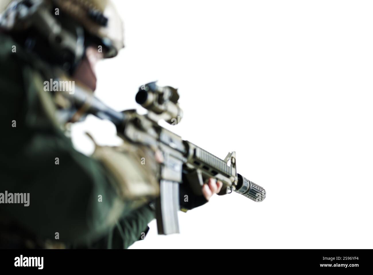 Tactical military soldier aiming a rifle in focus with intentional blur ...