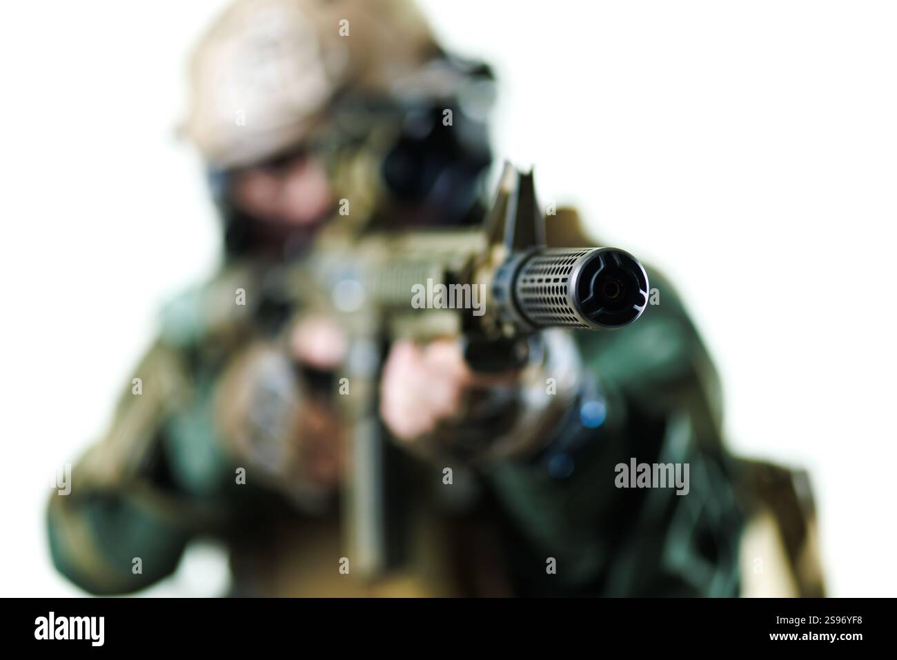 Blurred soldier holding a rifle in a tactical stance, wearing military ...