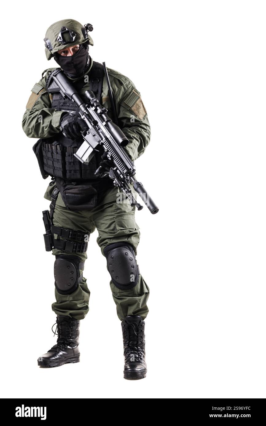 Tactical officer in green uniform and protective equipment, armed with ...