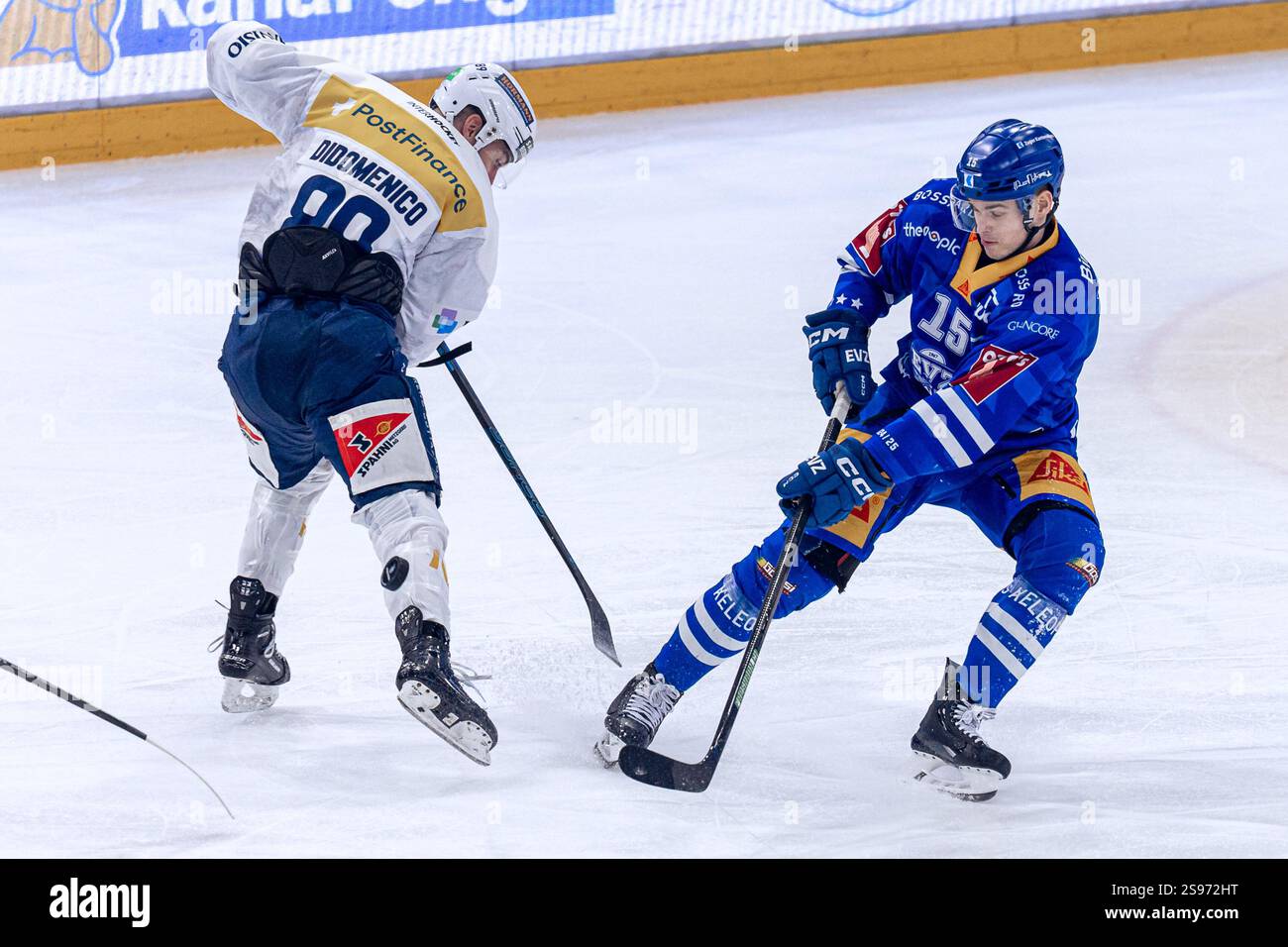 Gregory Hofmann #15 (EV Zug) stops Christopher DiDomenico #89 (HC Ambri ...