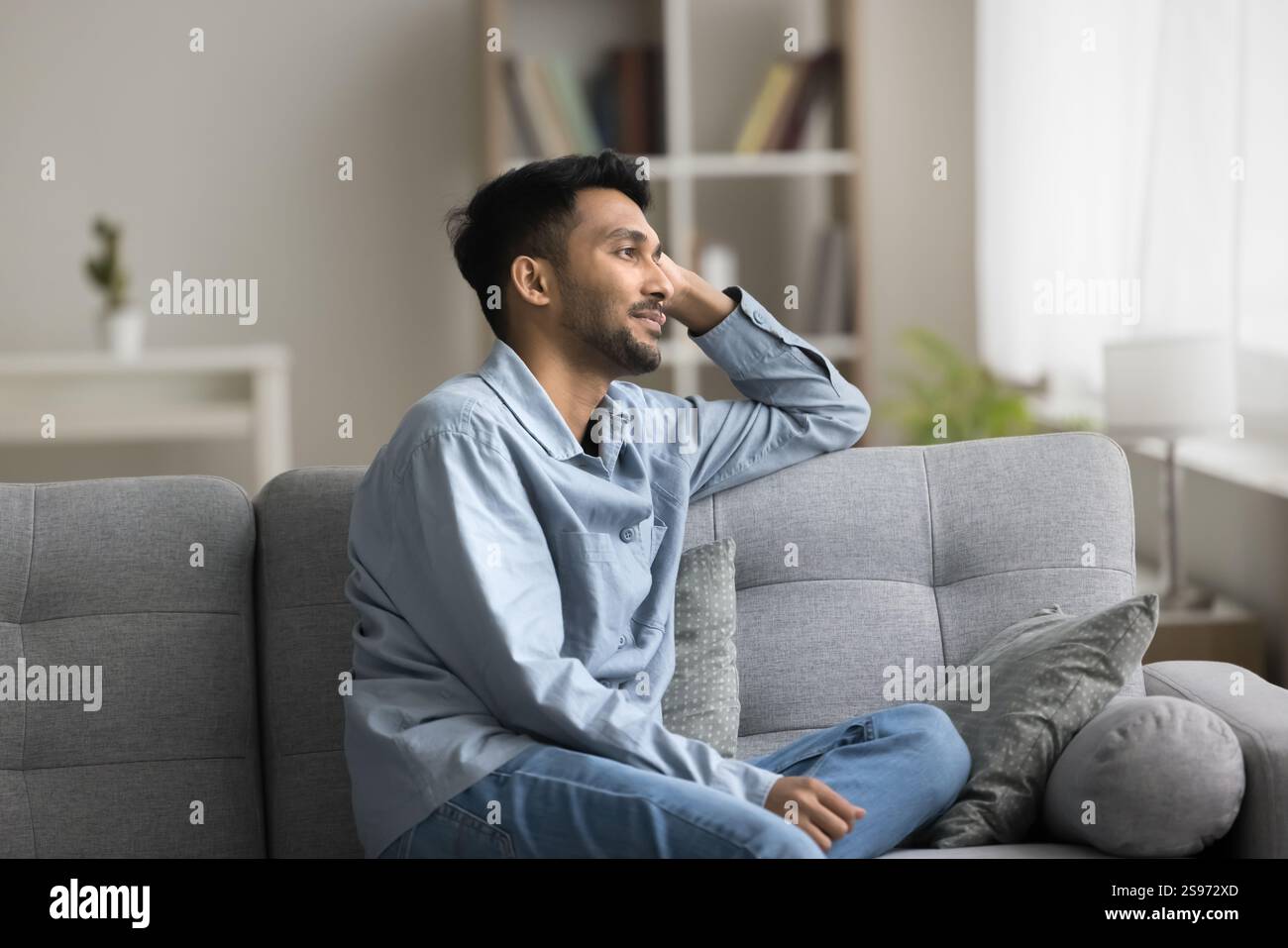 Happy millennial man relax sitting on sofa at comfortable pose Stock ...