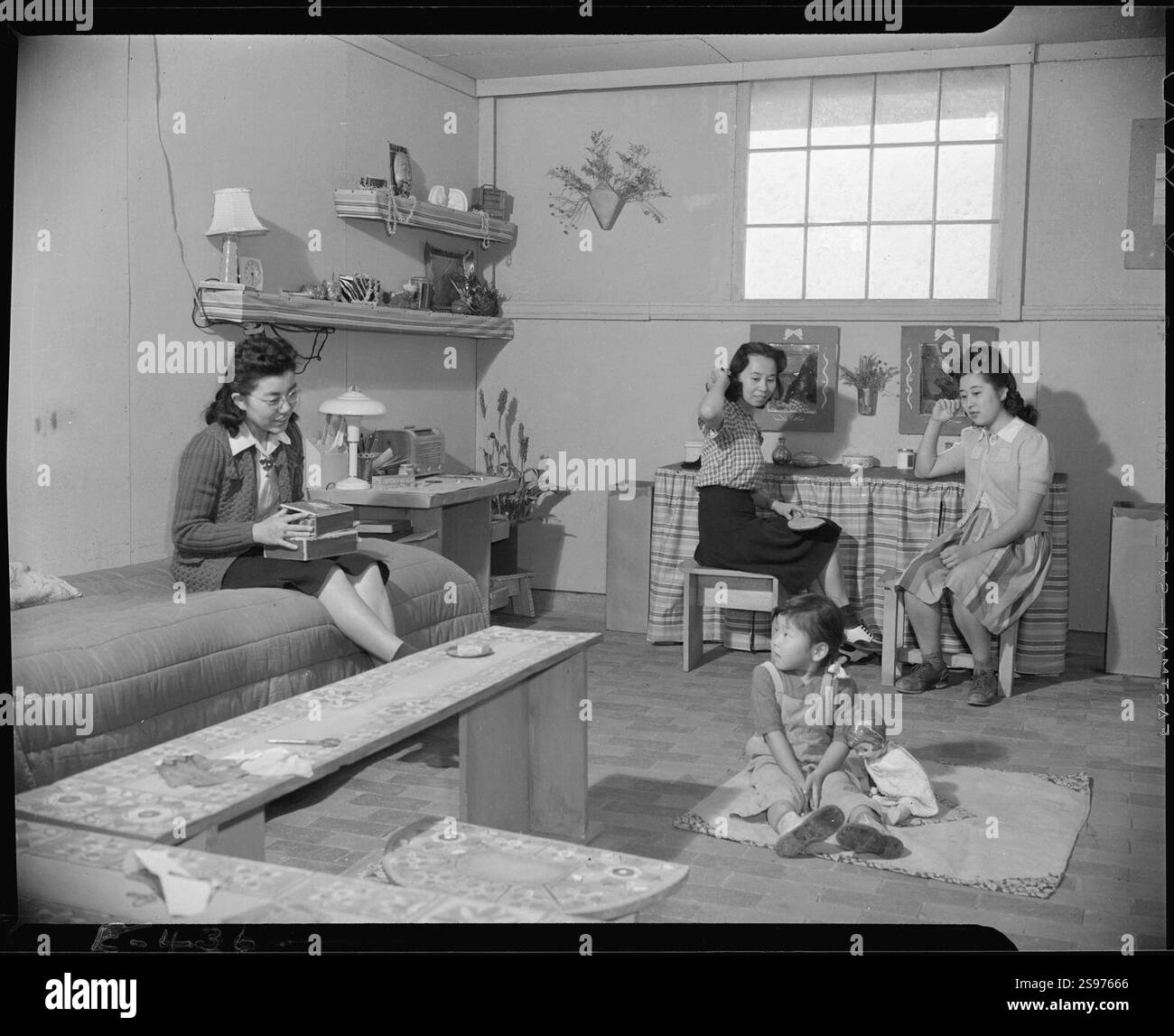 Granada Relocation Center. Two adult women and a small girl occupy this ...
