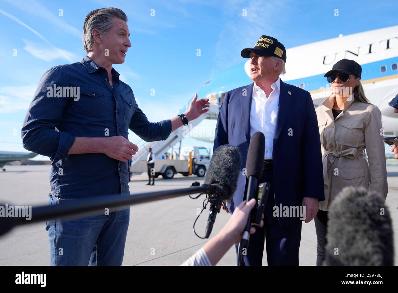 President Donald Trump and first lady Melania Trump listen to ...