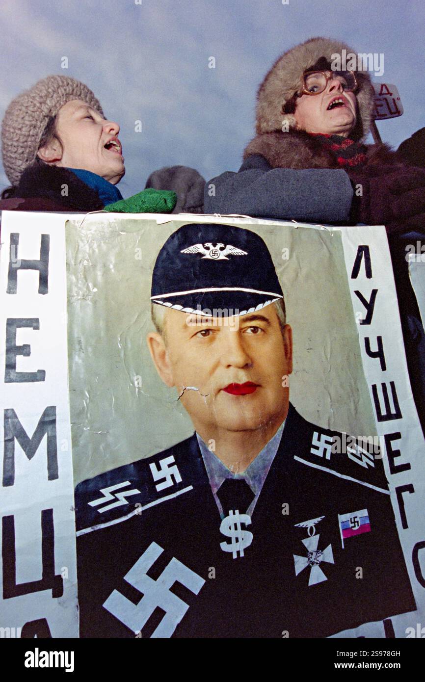 Members of the Russian Communist Labour Party stand behind a placard ...