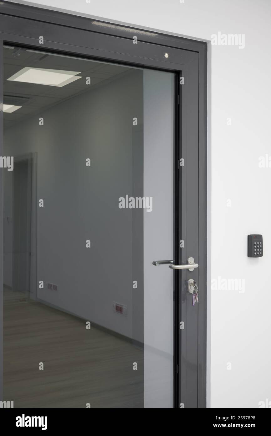 Modern Glass Door with Handle, Keys and Security Panel Stock Photo - Alamy