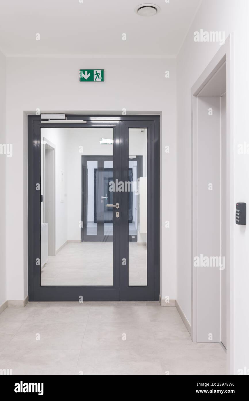 Modern Hallway with Emergency Exit Door and Access Control Stock Photo ...