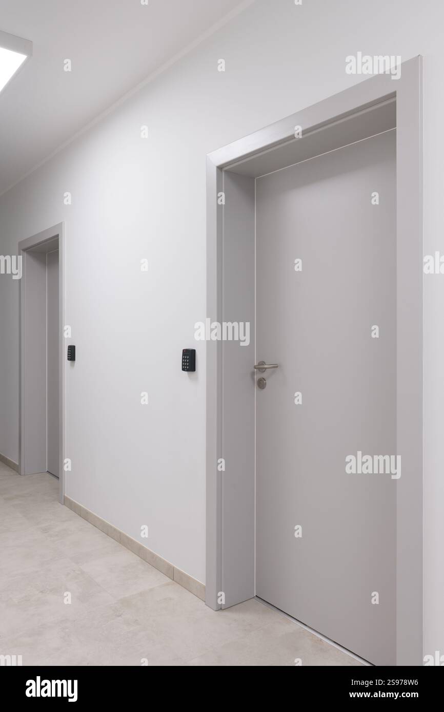 Modern Hallway with Doors and Security Keypads Stock Photo - Alamy