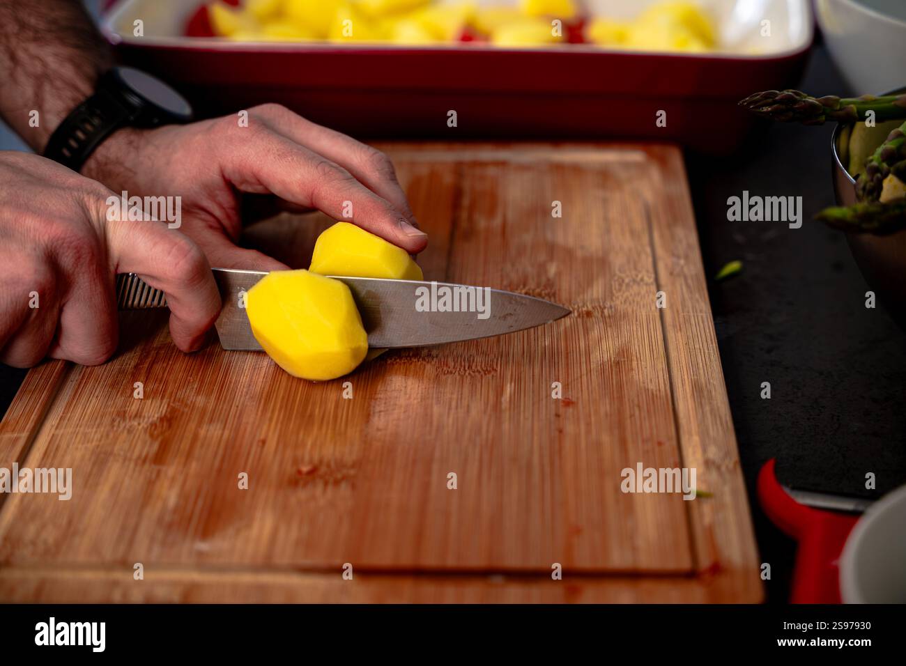 Cooking Prep, potato with Knife on Rustic Board Stock Photo - Alamy