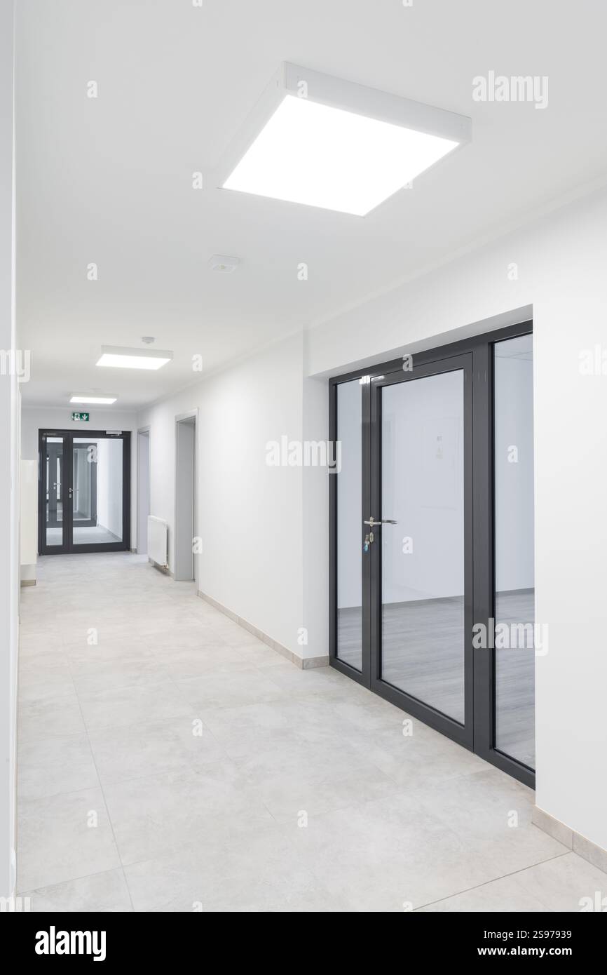 Modern Hallway with Glass Doors and Lighting Fixtures Stock Photo - Alamy