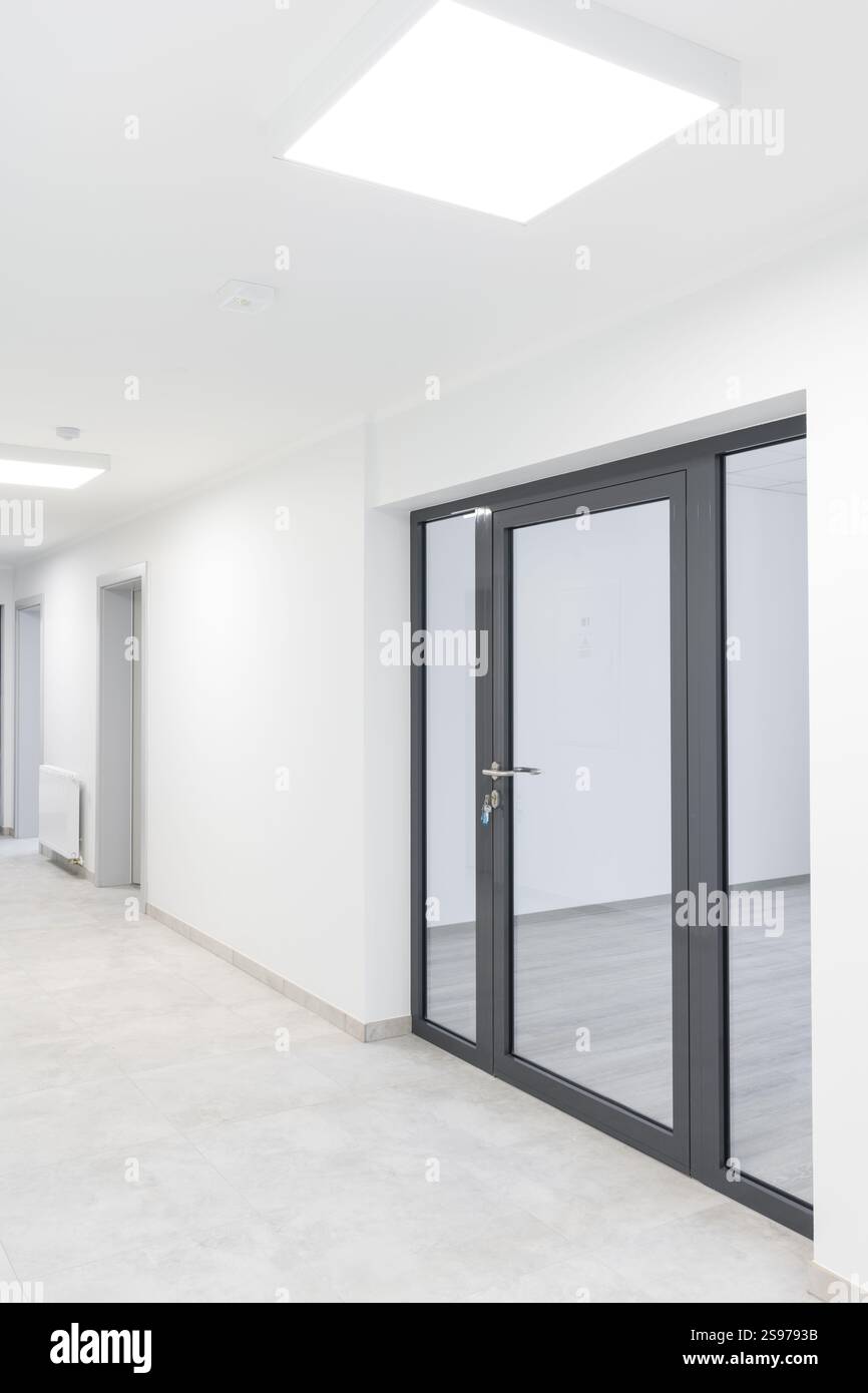 Modern Hallway with Glass Doors and Lighting Fixtures Stock Photo - Alamy