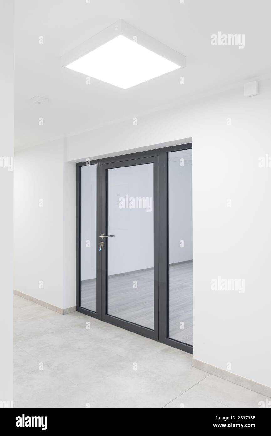 Modern Hallway with Glass Doors and Lighting Fixtures Stock Photo - Alamy