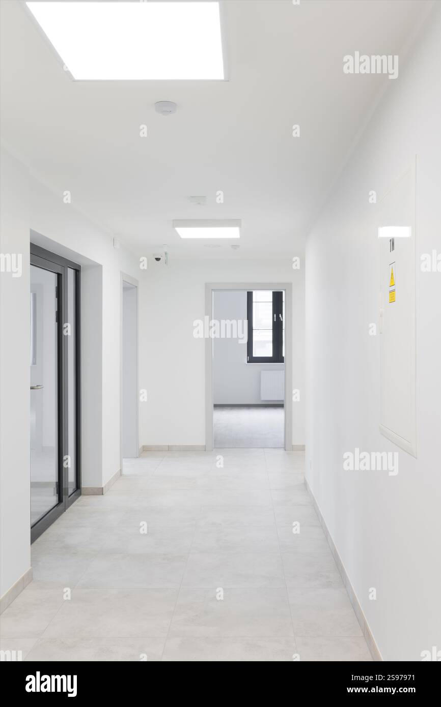 Modern Hallway with Glass Doors and Lighting Fixtures Stock Photo - Alamy