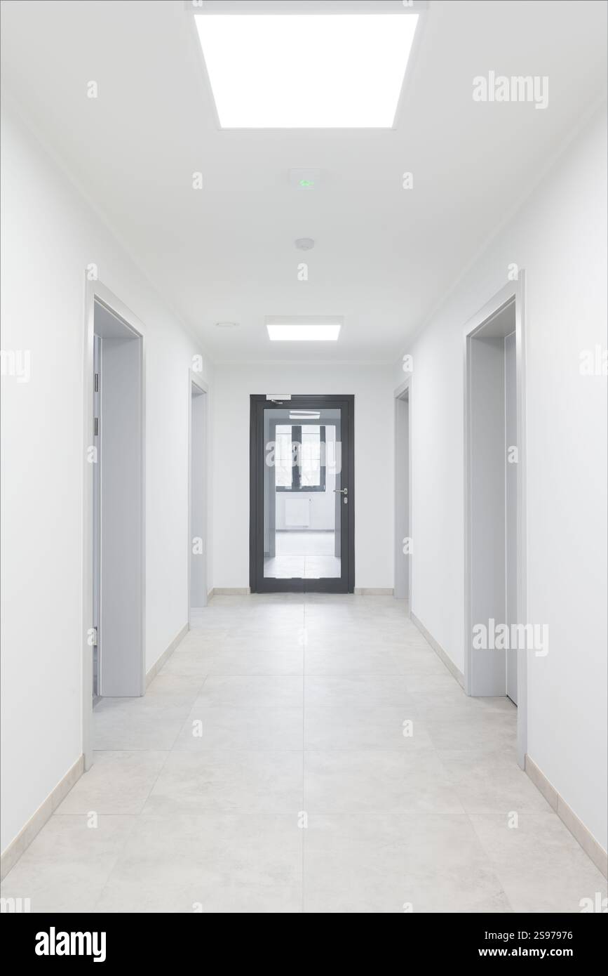 Modern Hallway with Glass Doors and Lighting Fixtures Stock Photo - Alamy