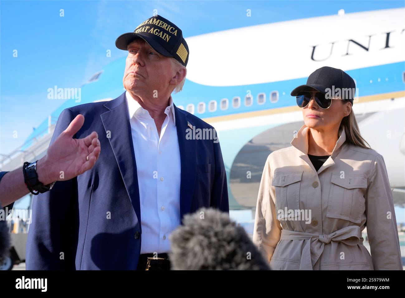 President Donald Trump and first lady Melania Trump listen to ...