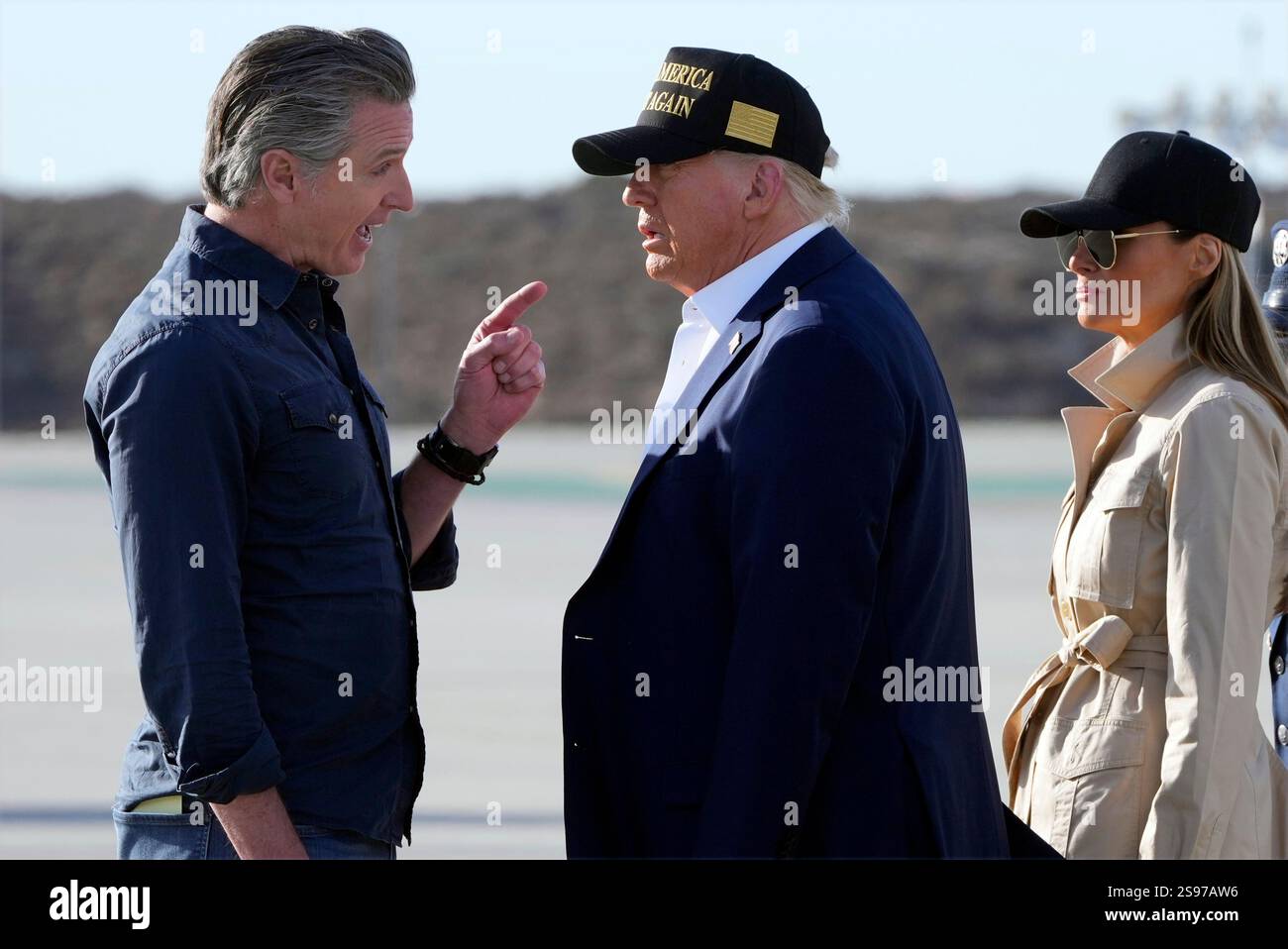 President Donald Trump and first lady Melania Trump listen to ...