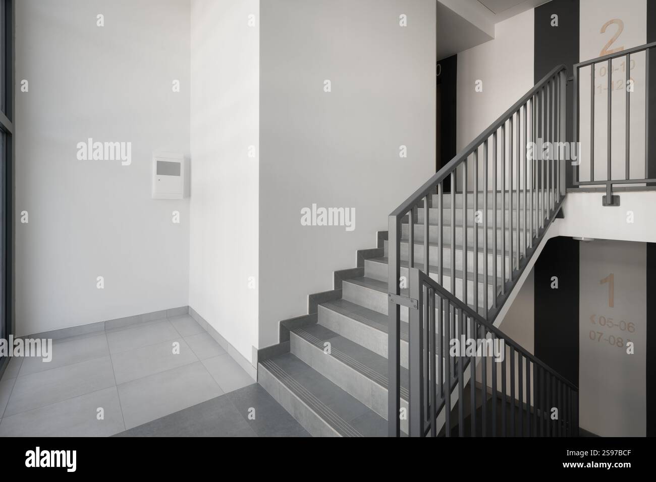 Modern Staircase with Gray Steps and Metal Railings Stock Photo - Alamy