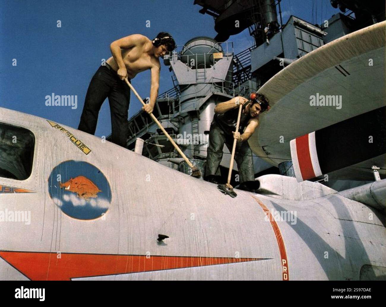 Grumman E-2A Hawkeye of VAW-114 is cleaned aboard the USS Kitty Hawk ...