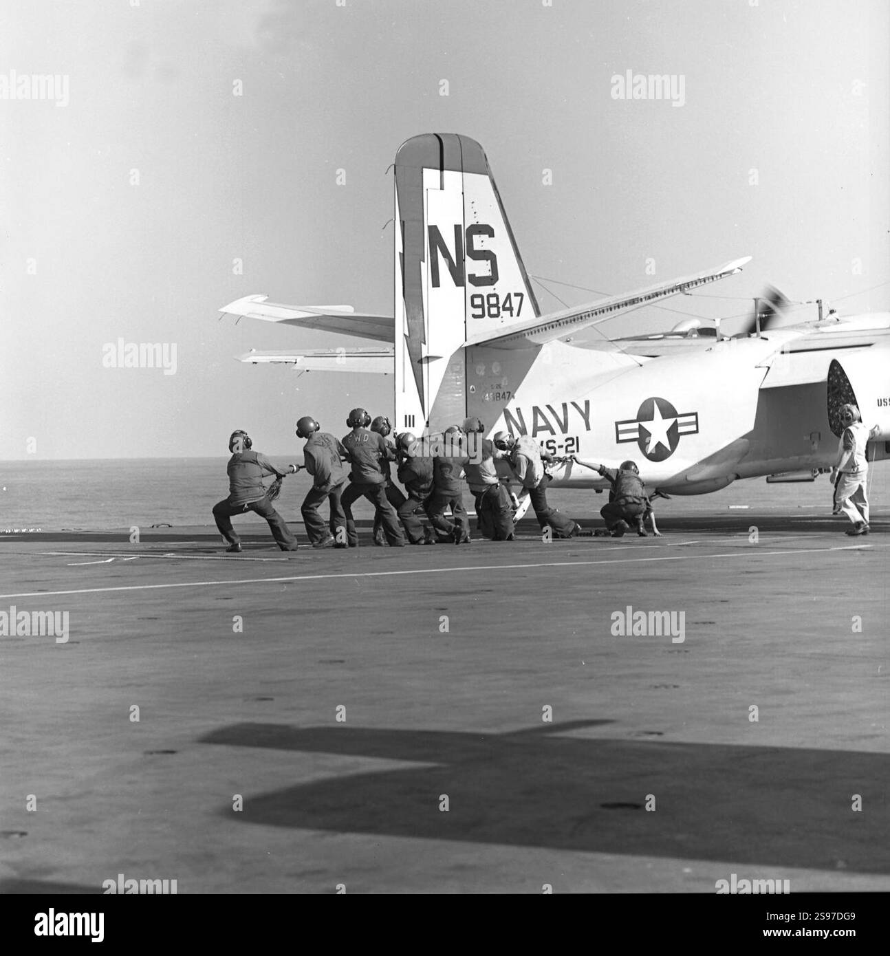 Grumman S-2E Tracker of VS-21 is pulled to a catapult aboard USS ...