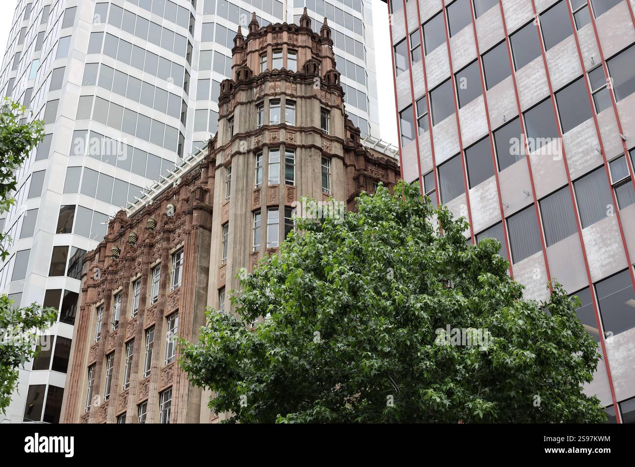 historic stone building pinned between two modern skyscrapers Stock ...