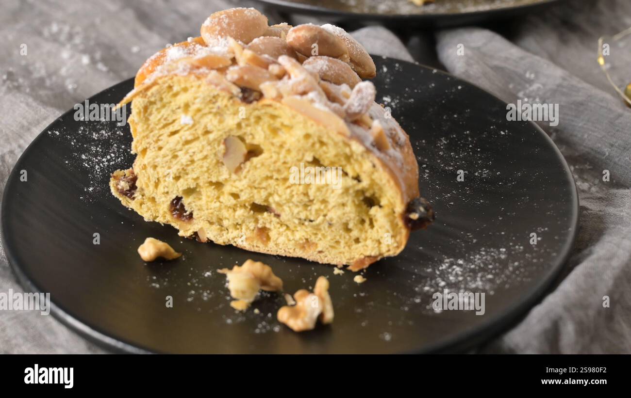 A slice of Bolo Rainha, a traditional Portuguese sweet bread, dusted ...