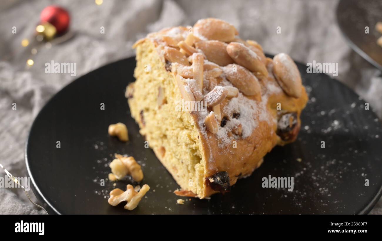 A slice of Bolo Rainha, a traditional Portuguese sweet bread, dusted ...