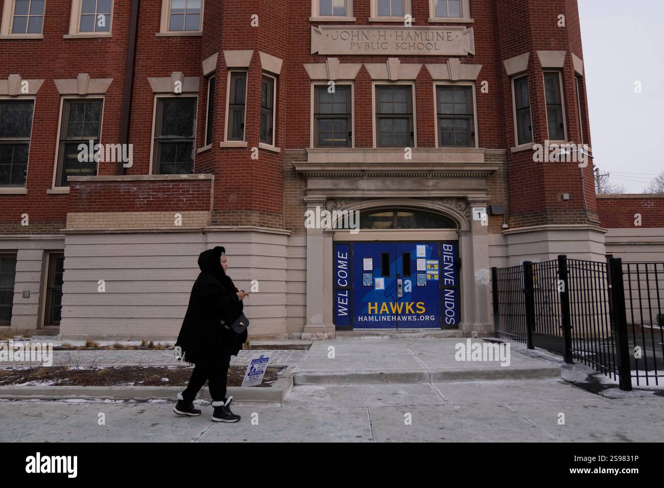 A person walks by Hamline Elementary School after federal agents were ...