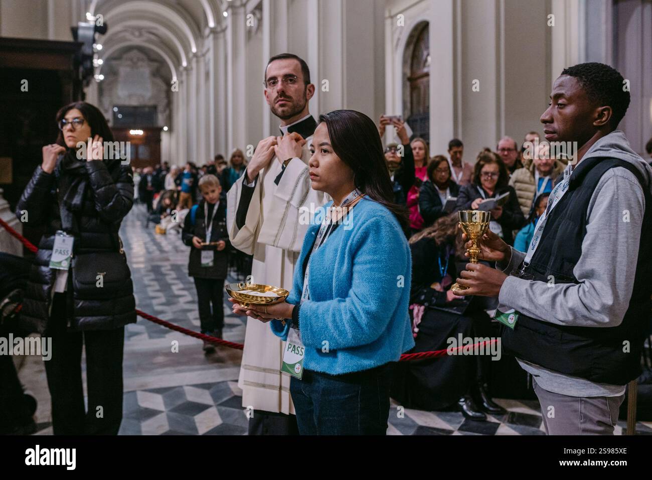 The faithful seen holding objects for the offertory during the ...
