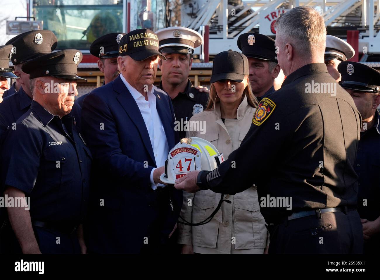 President Donald Trump is presented with a firefighters helmet as he ...