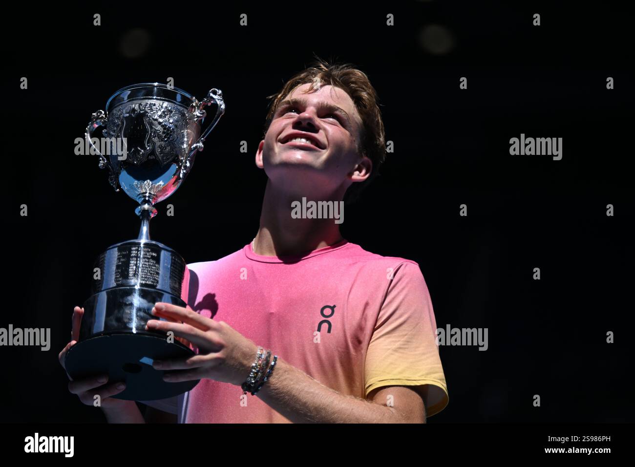 Henry Bernet of Switzerland holds the winners trophy following his ...