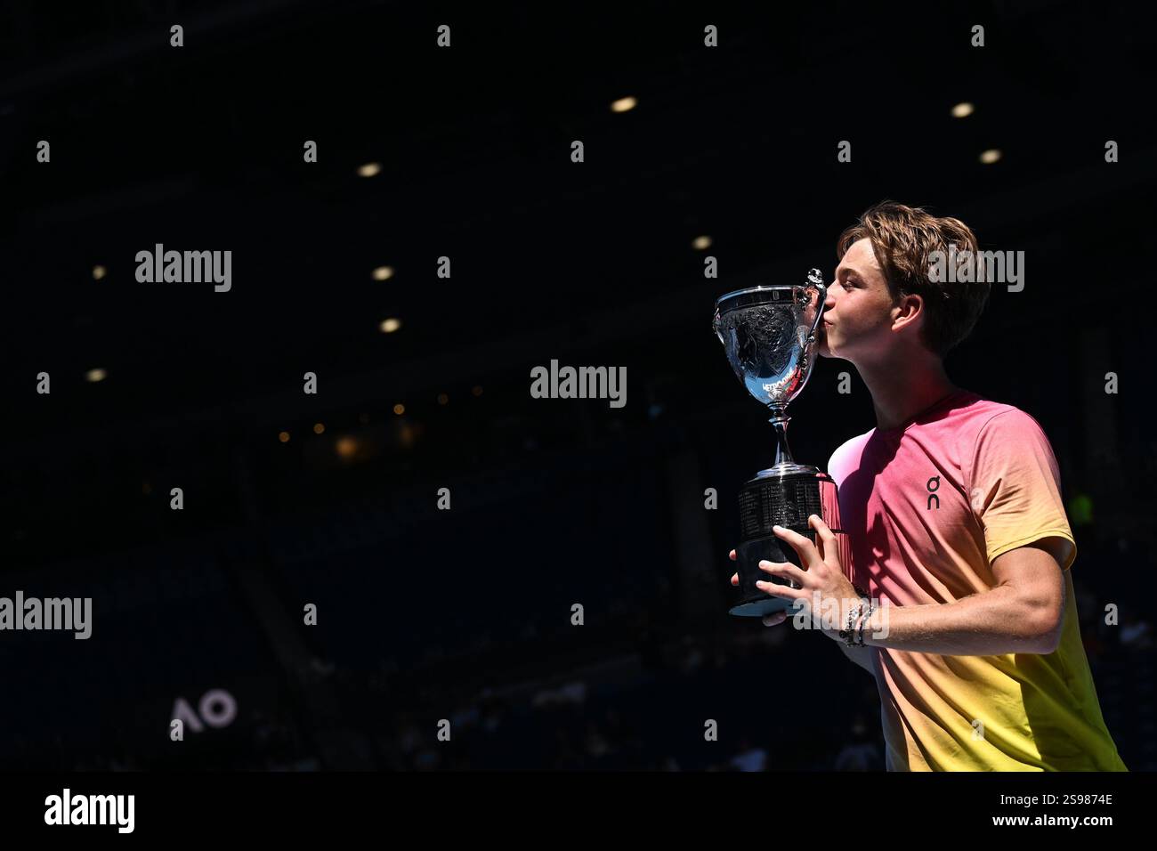 Henry Bernet of Switzerland holds the winners trophy following his ...
